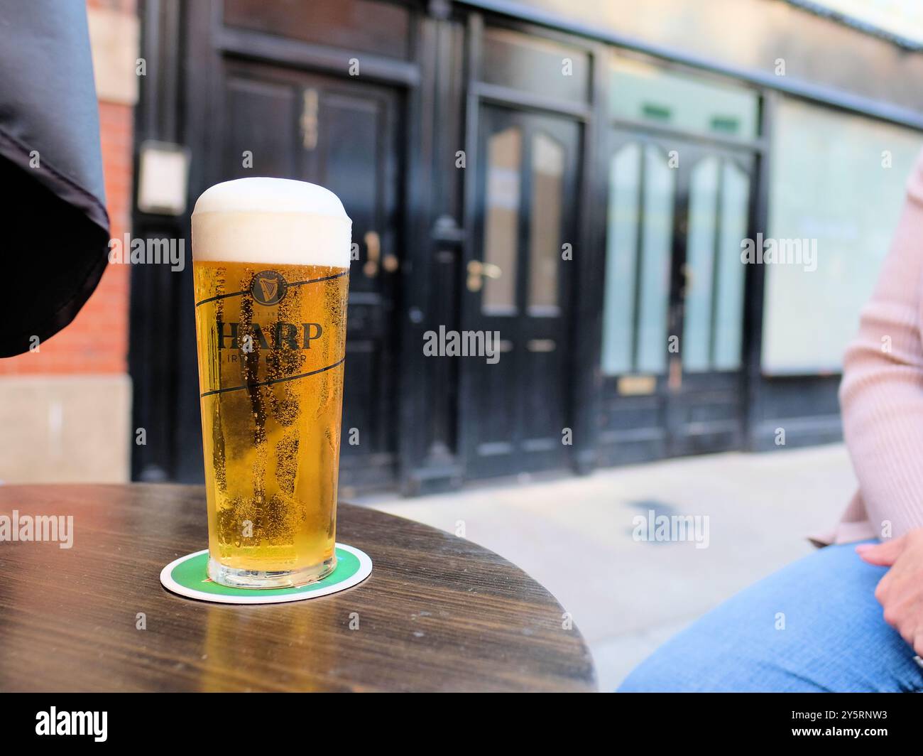 A branded glass of Harp lager; an Irish beer created in 1960 by ...