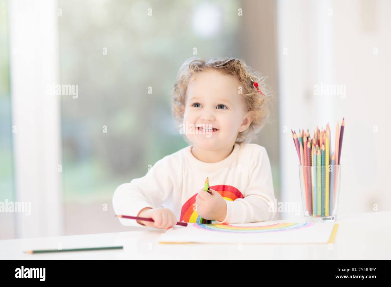 Kids paint. Child painting in white sunny study room. Little girl ...