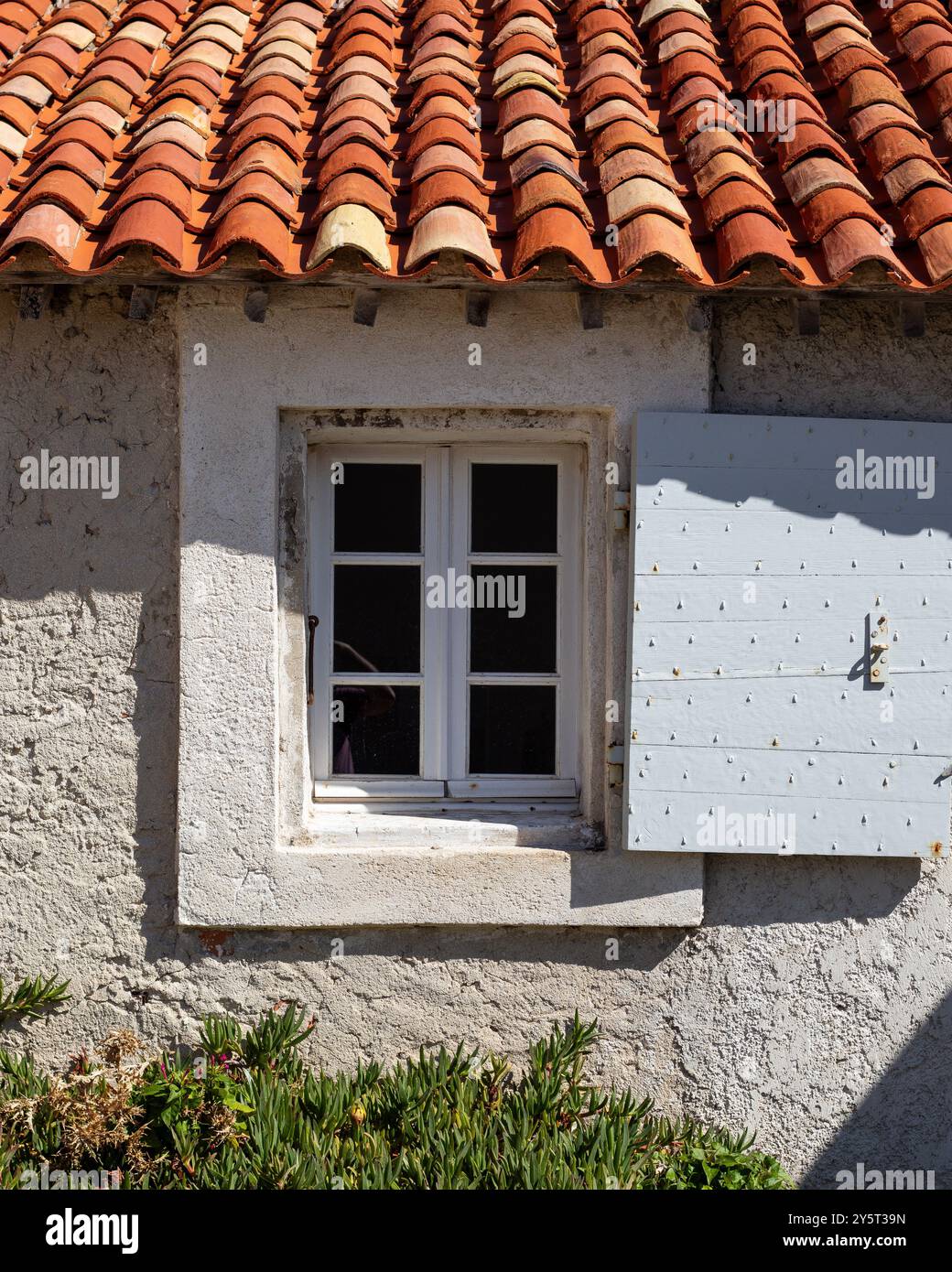 Mediterranean Cottage with window, shutter and Spanish tiles in mid-day ...