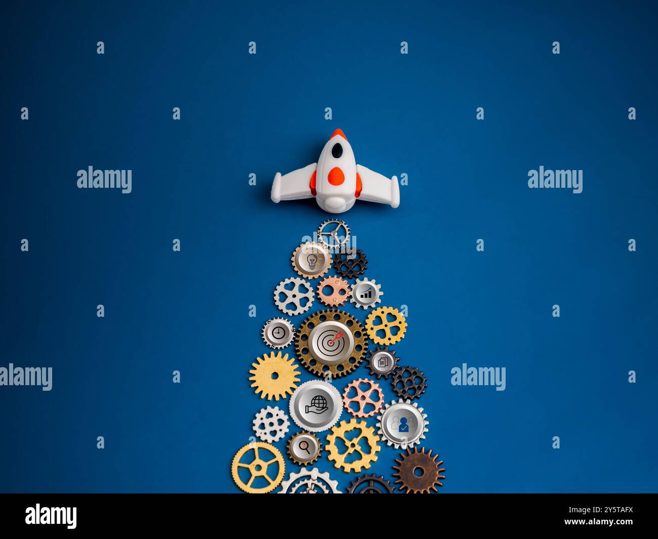 White spaceship rocket fly with many cog gears as jet smoke on blue ...