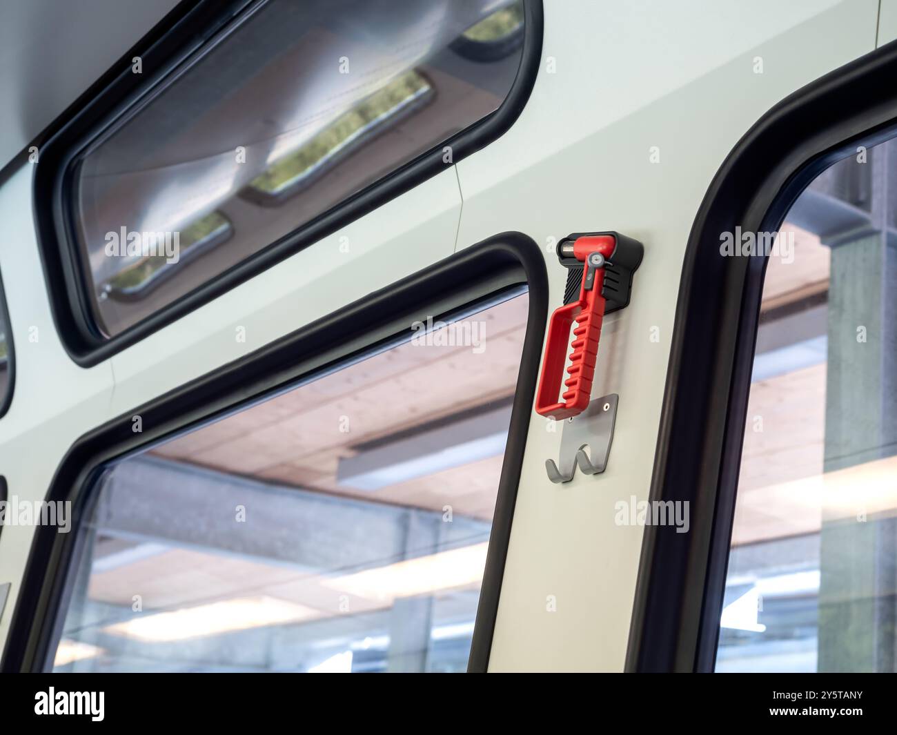 Red safety hammer mounting, tools near the window glass on the train or ...
