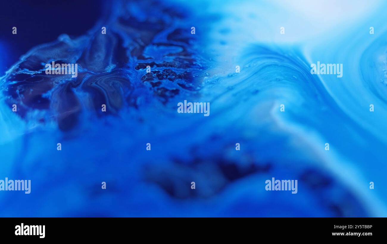 Paint flow. Liquid spill. Defocused blue color glowing acrylic emulsion ...