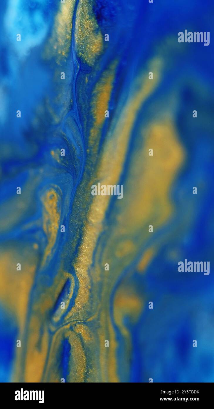 Paint splash. Sparkling fluid. Defocused blue golden color glitter ...