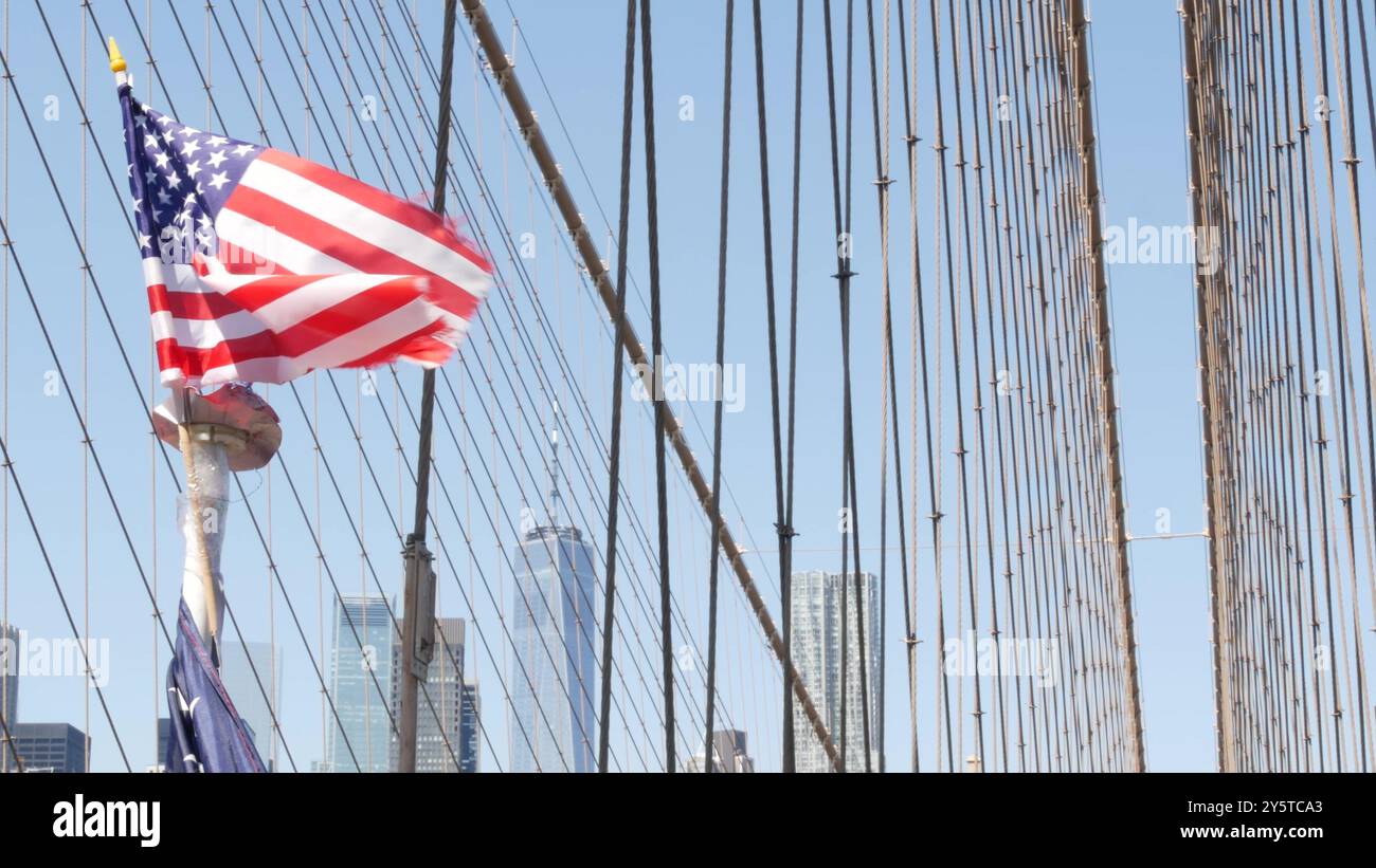 Flag on Brooklyn Bridge, Manhattan downtown, New York City skyline ...