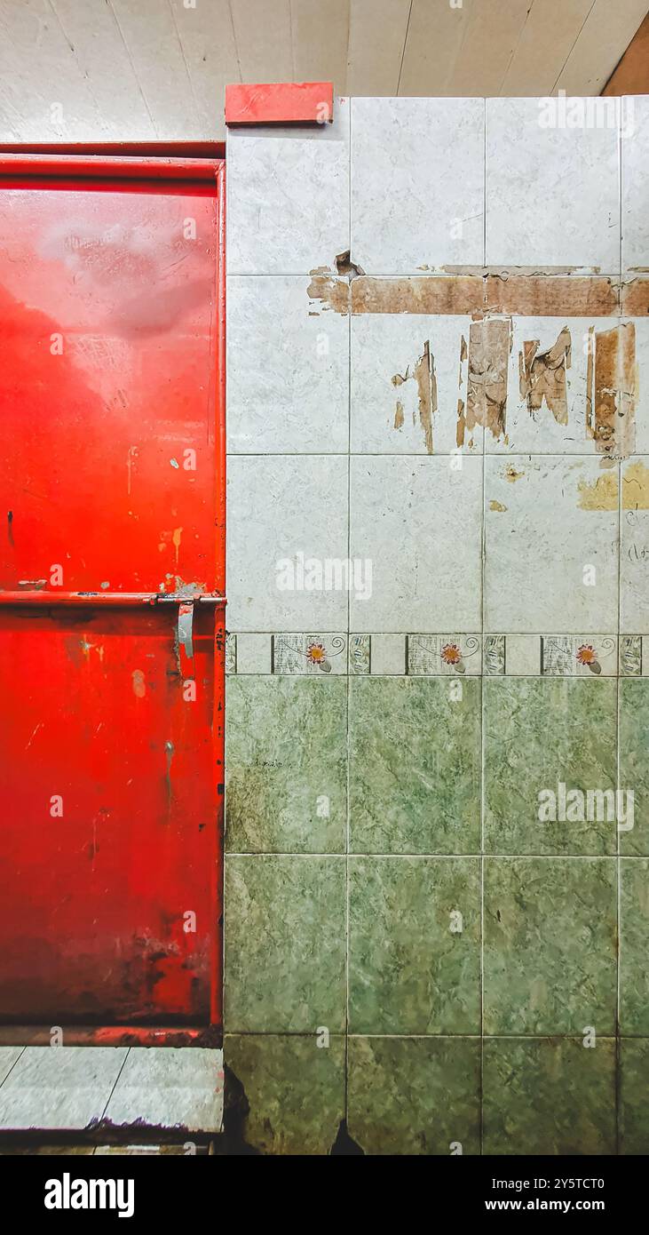 Eerie Red Doorway. The toilet door is worn and looks dirty against the ...