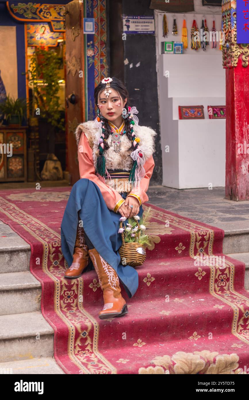 Lhasa, Tibet, July 3, 2022: Lady posing at ancient temple door in a ...