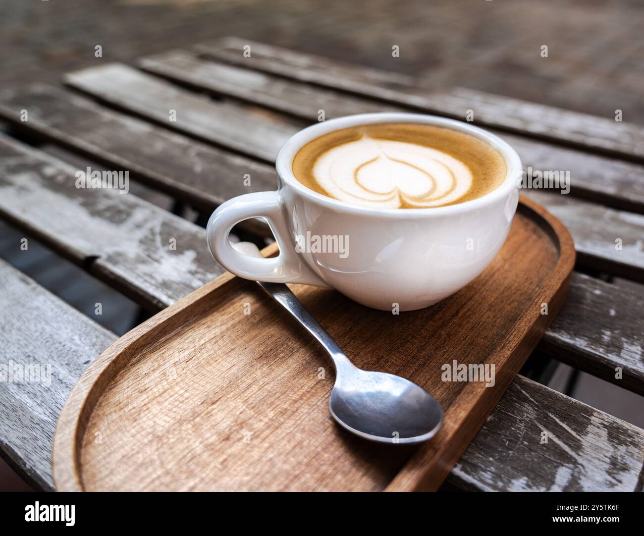 Coffee cup restaurant outside table. Flower heart shape foam drawing ...