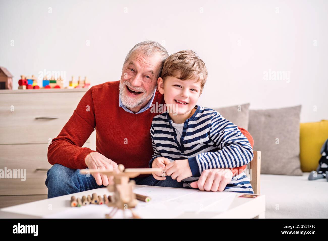 Grandfather spending time with grandson, taking care of him while ...