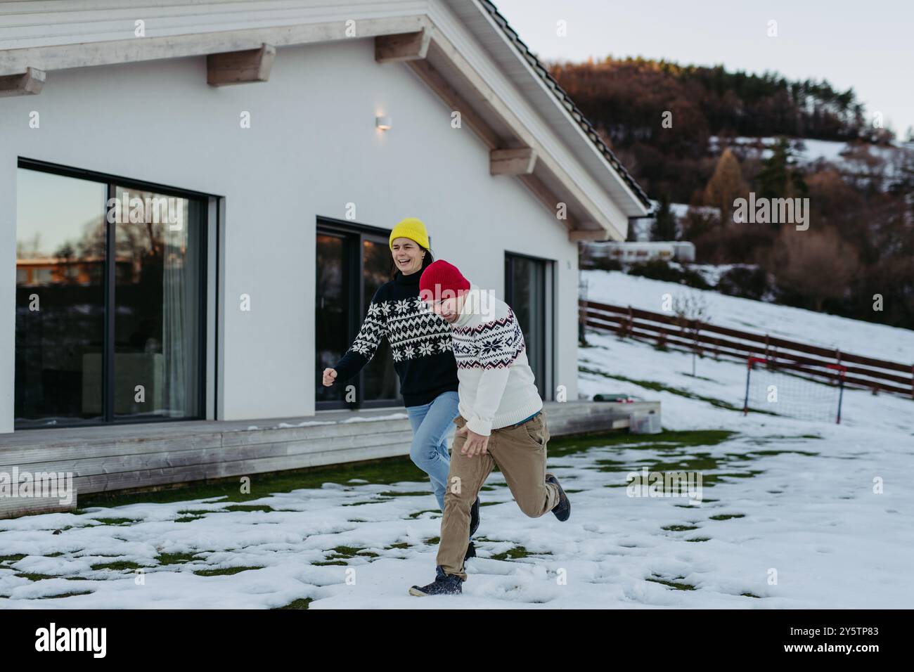 The mother and young man with Down syndrome are outside, having fun, running and ejoying first ...