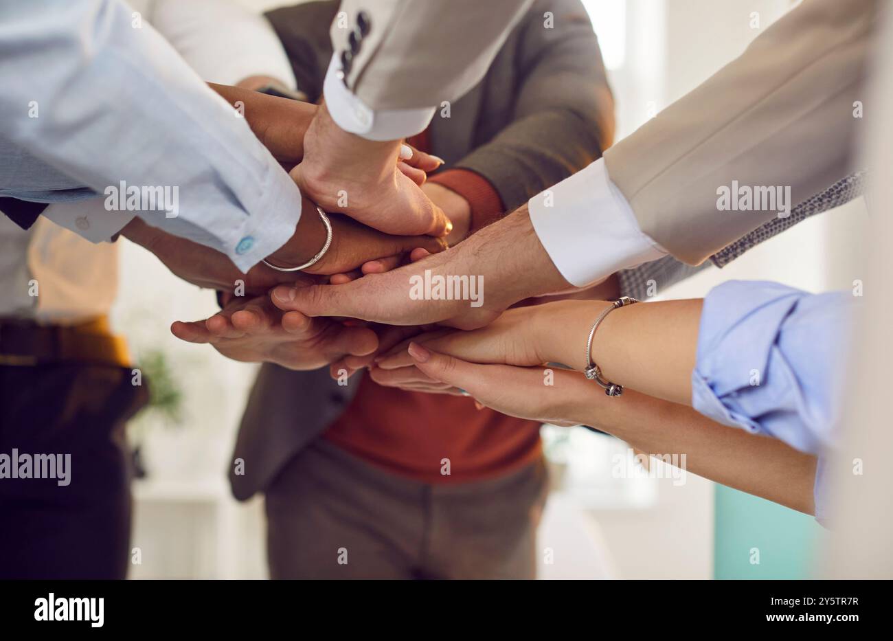 High five together, multi ethnic corporate office business team winners join hands, success ...