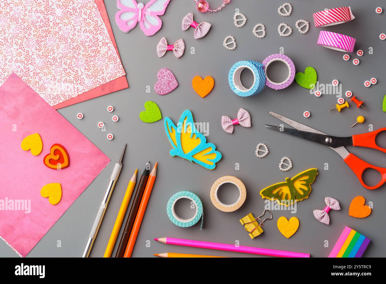 Crafting materials and tools arranged on a gray surface during a ...