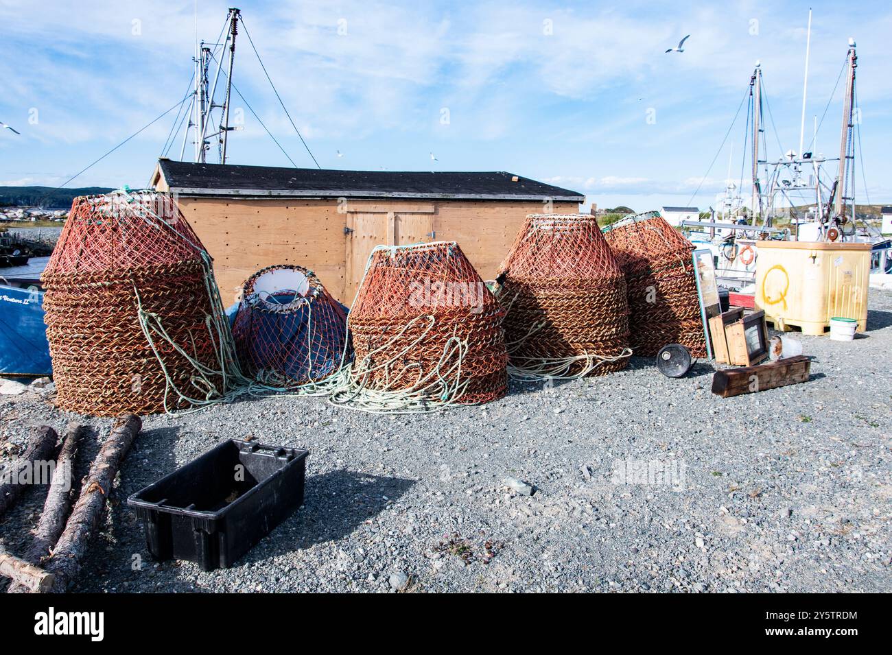Crab traps stored beside a fishing shed on the beach in Ferryland ...