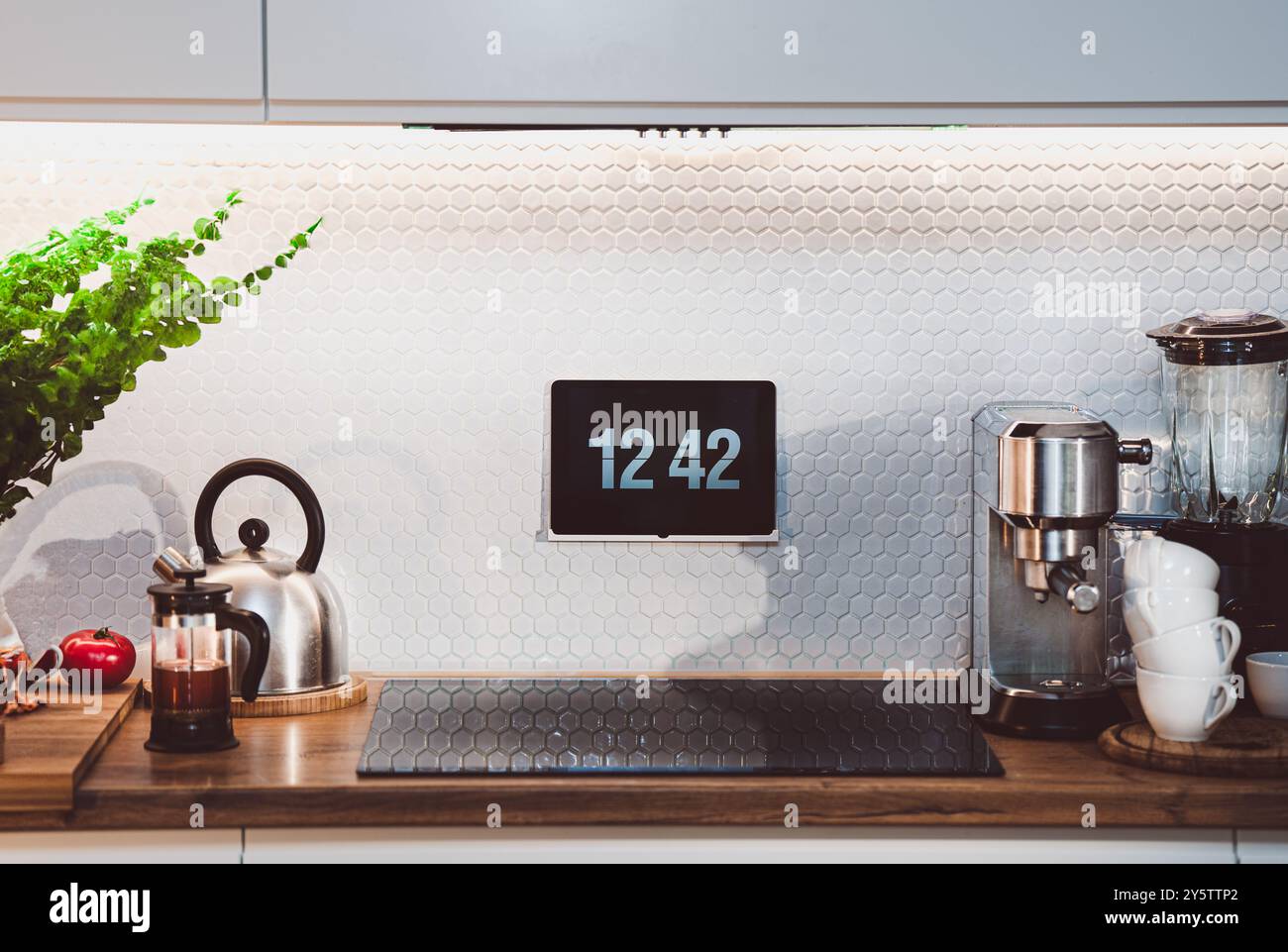 Smart home clock screen. Home interior. Induction hob kitchen ...
