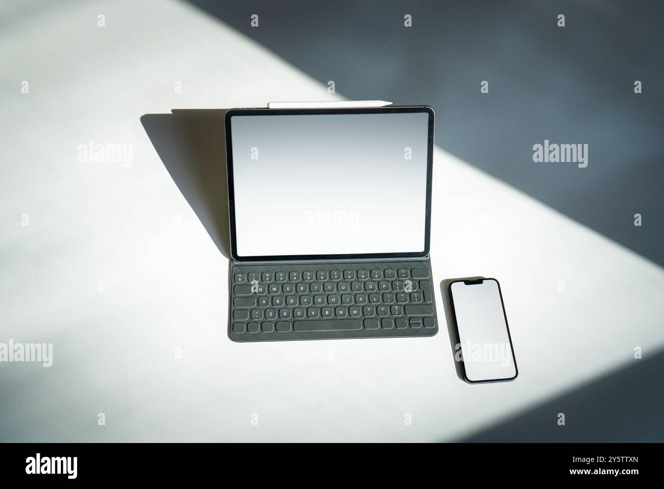 White screen clean laptop smartphone screen. Light background shadows ...