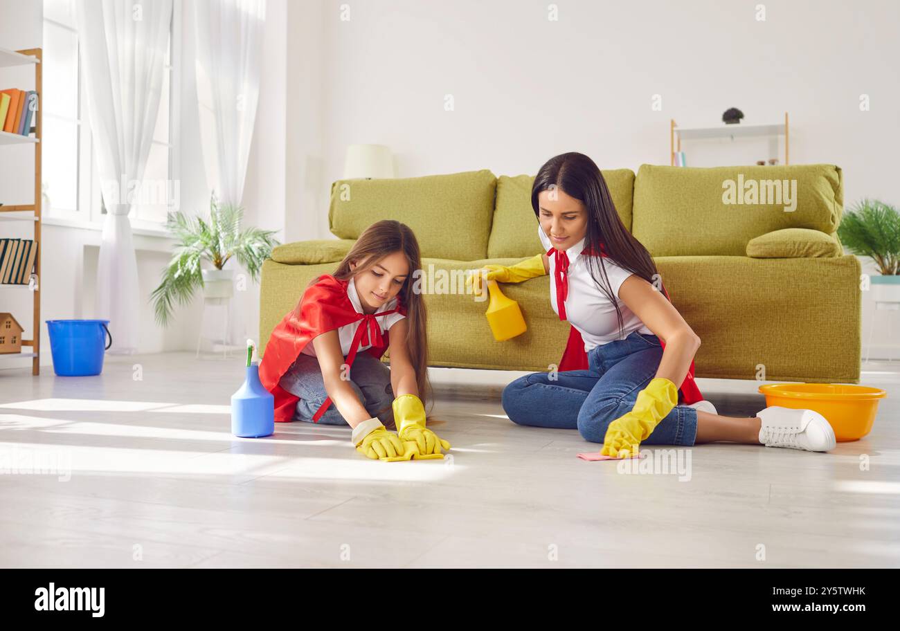 Mother And Daughter In Superhero Costumes Cleaning House Stock Photo ...
