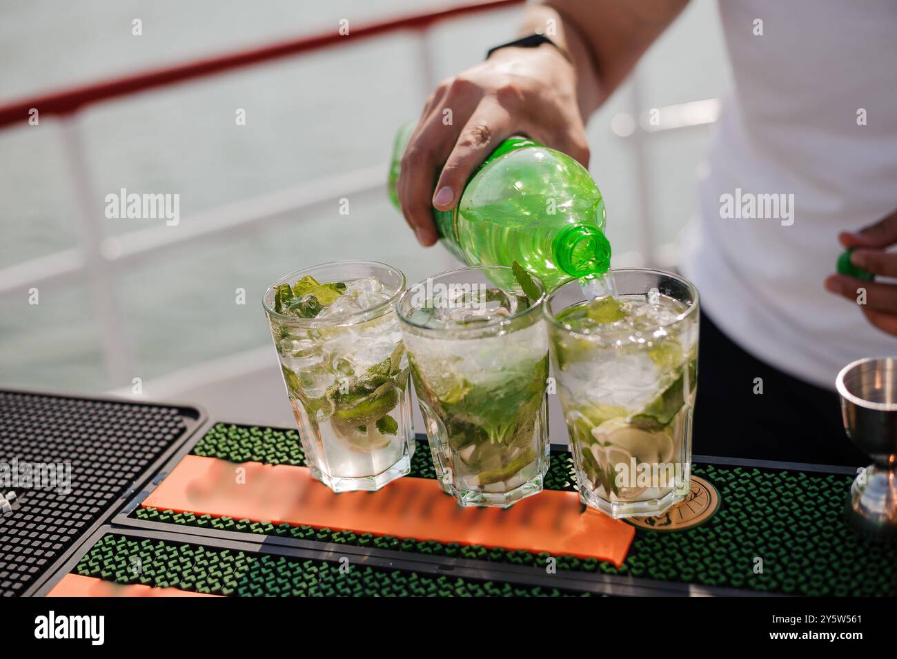 Refreshing Mojito Preparation on a Sunlit Deck with Sprigs of Mint and Sparkling Water Stock ...