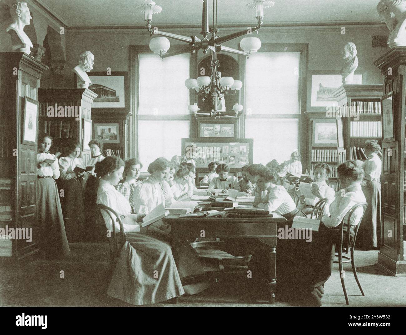 Vintage photo of group of young women reading in library of normal ...