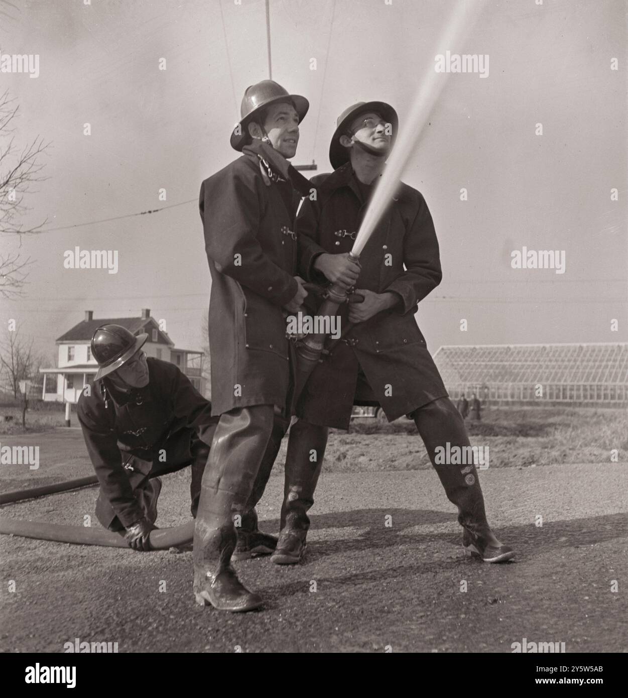 America of the 1940s. Volunteer firemen practicing during an air raid ...