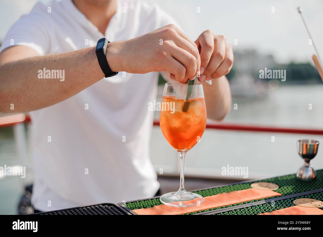 Refreshing Summer Cocktail Preparation with Citrus Garnish on a Scenic ...