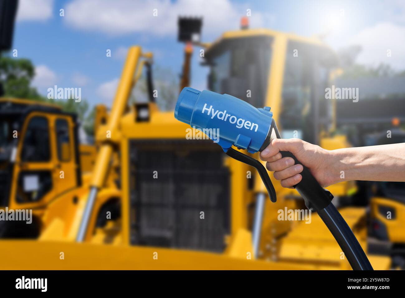 Hand with hydrogen fueling nozzle on a background of fuel cell ...