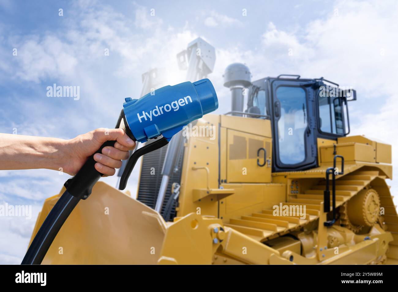 Hand with hydrogen fueling nozzle on a background of fuel cell ...
