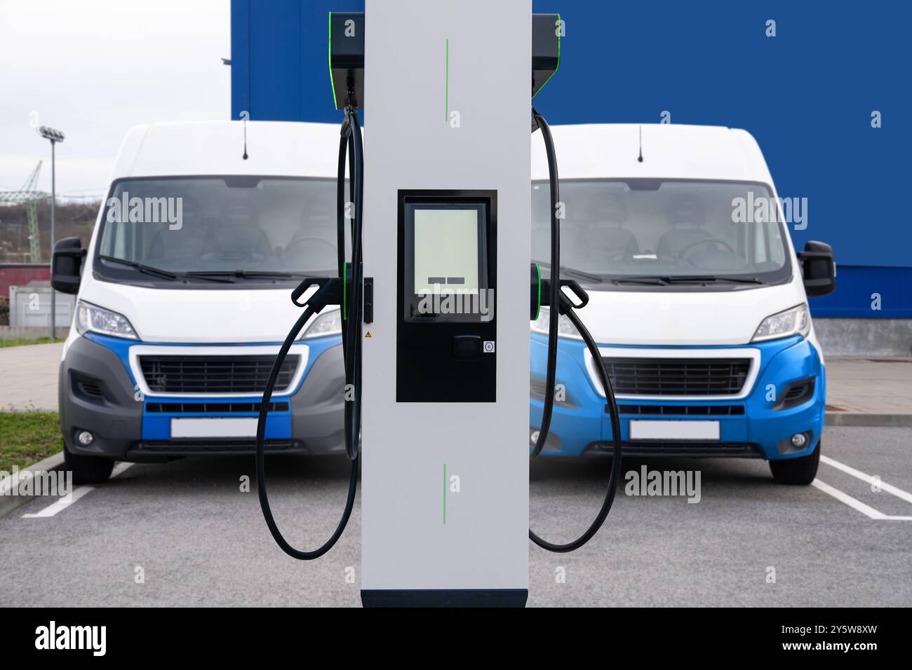 Electric delivery vans with electric vehicles charging station Stock ...