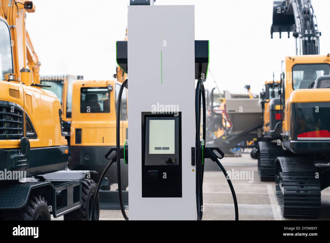 Electric construction machines with charging station. Concept Stock ...