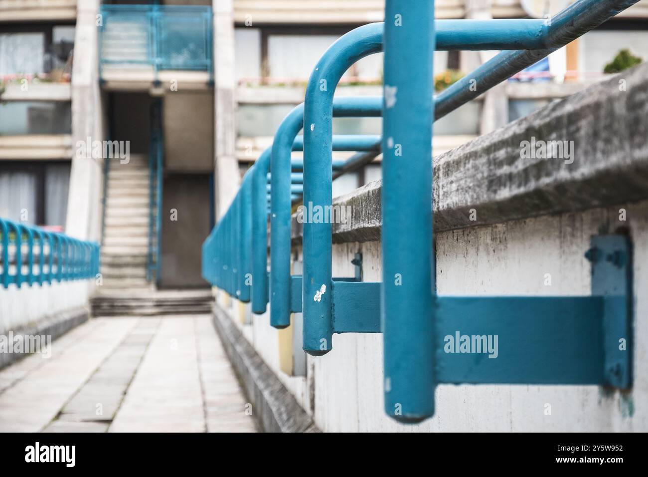 Metal railings of concrete walkway at Alexandra Road estate, a ...
