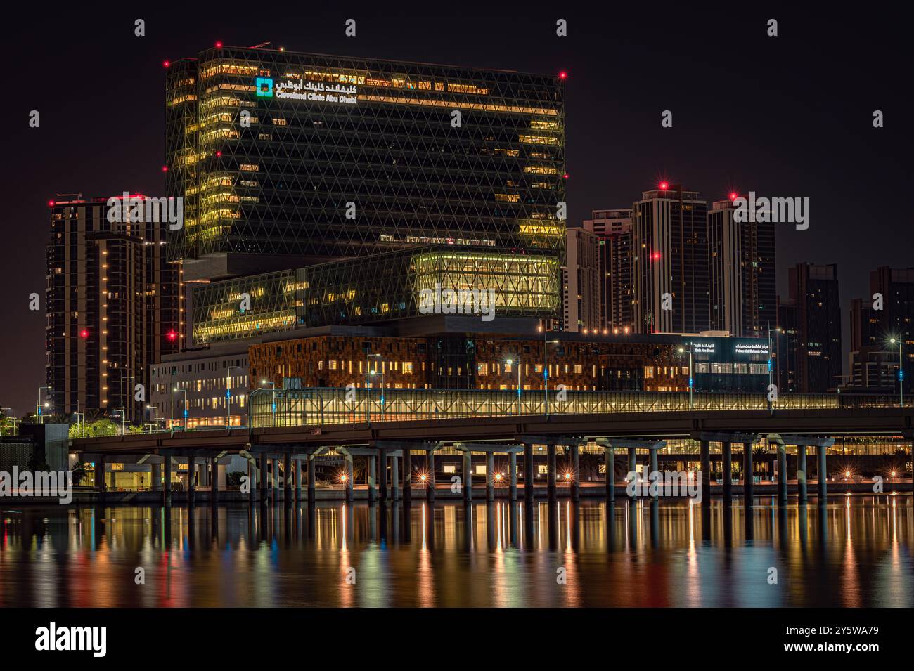 Cleveland Clinic Abu Dhabi. The modern building glows with lights ...