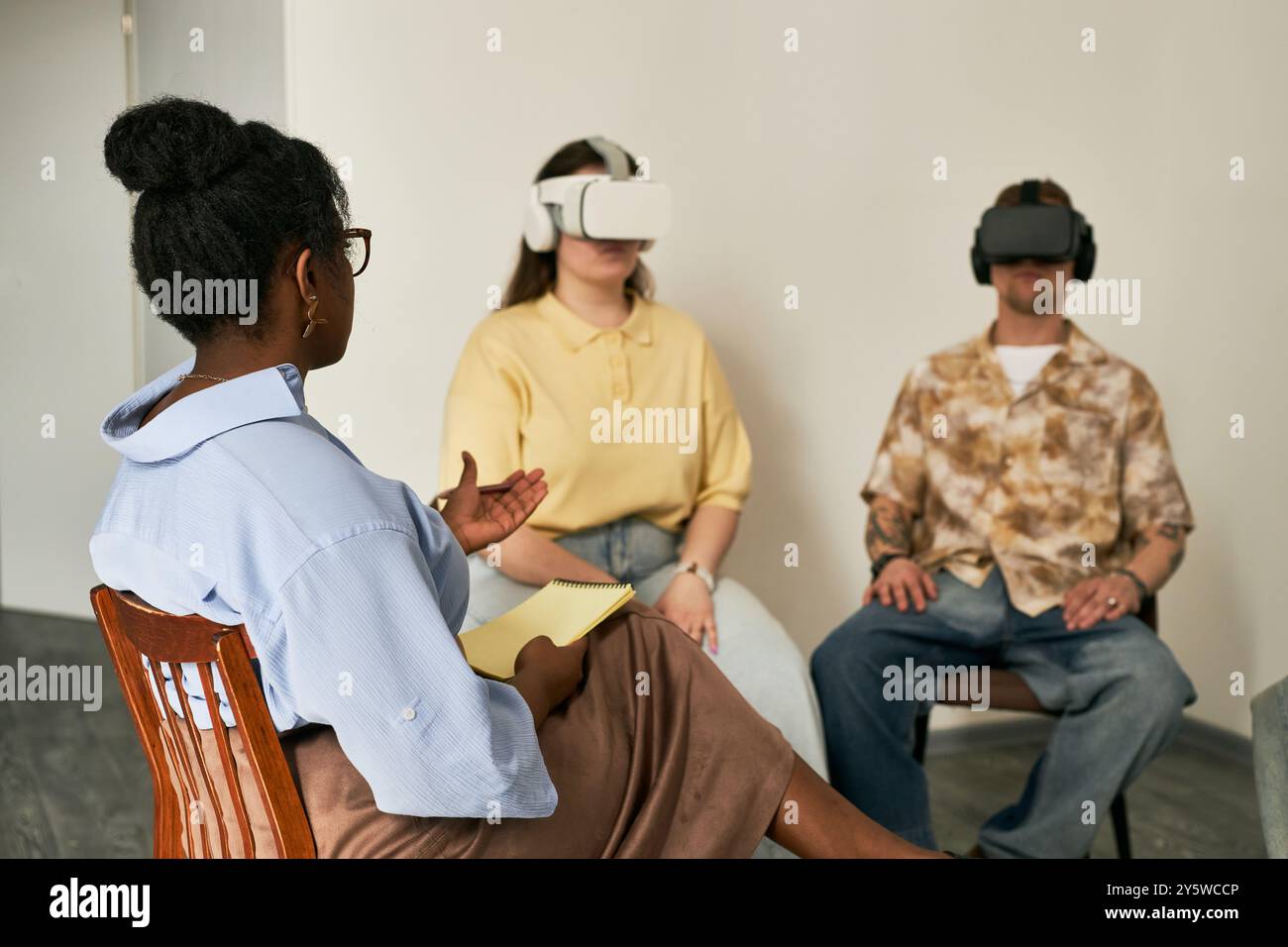 Three people engaging virtual reality experience in education setting ...