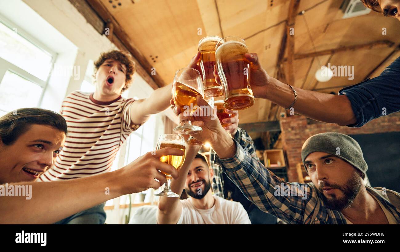 Celebration hits high as all guys raise their glasses for victory toast ...