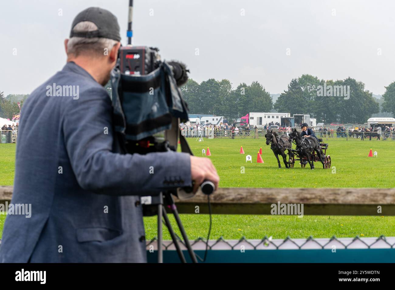 Camera man filming scurry driving races in the arena at Newbury Show ...