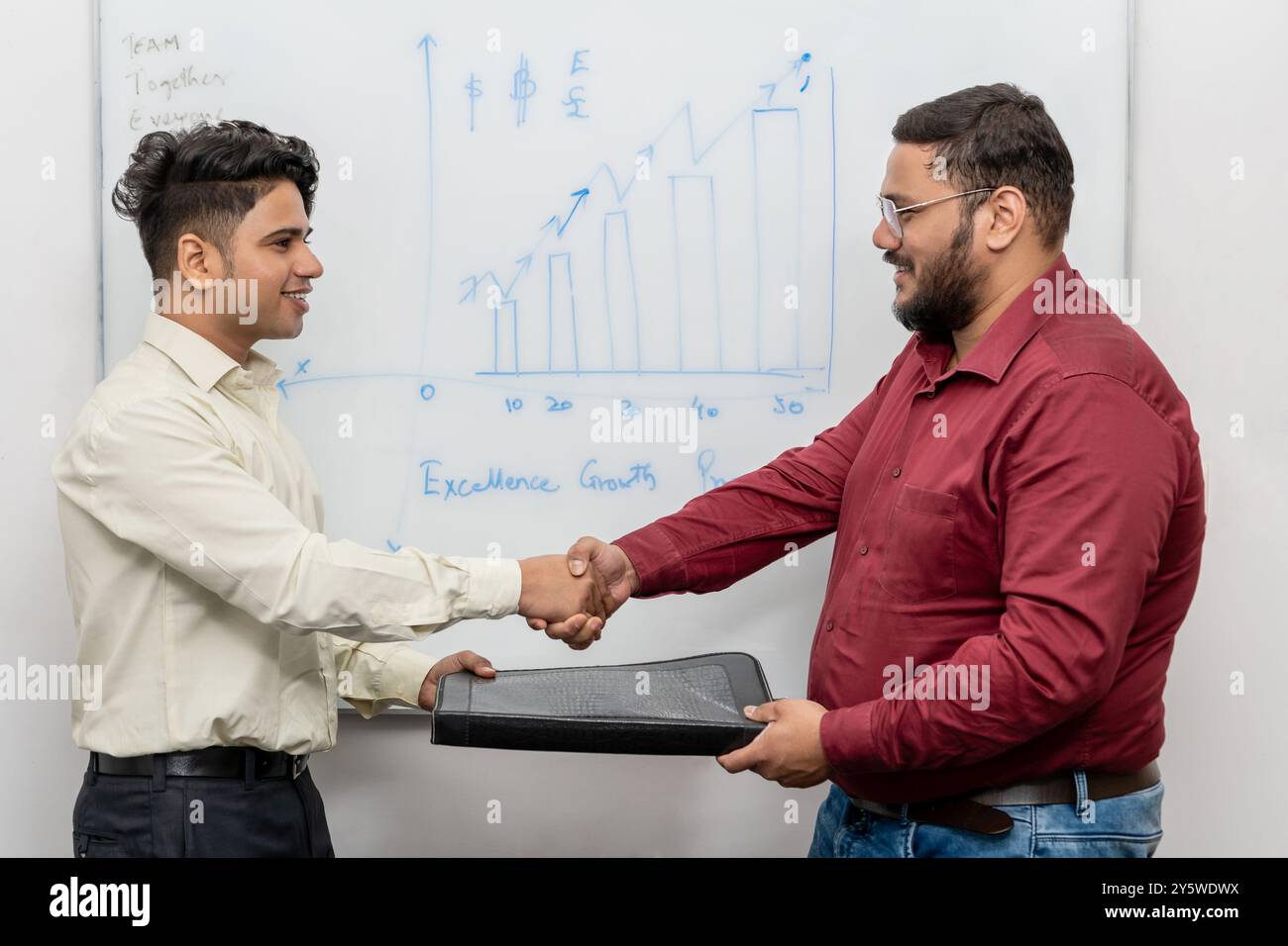 Two Indian businessmen handshake for agreement and partnership for a ...
