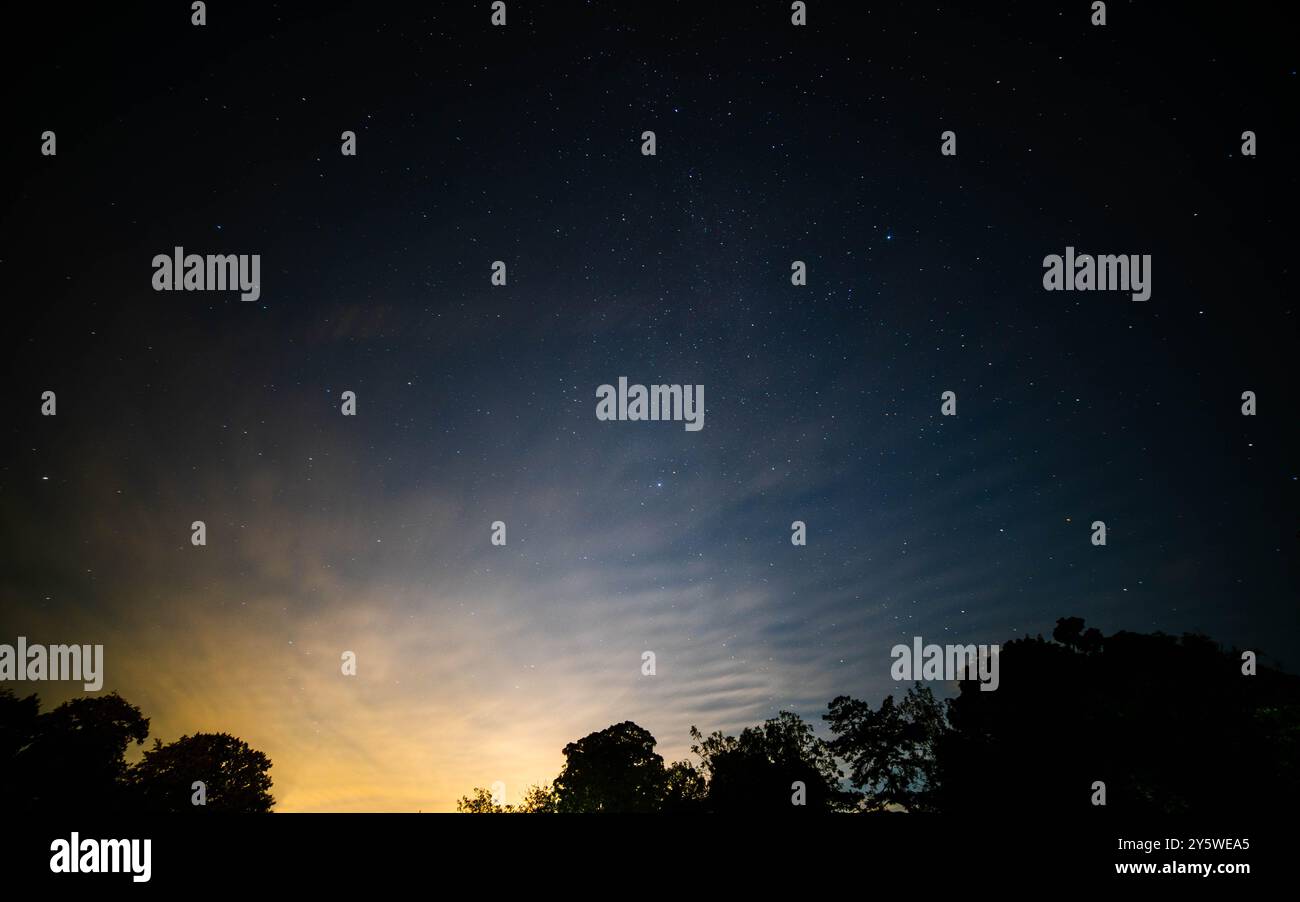 clouds, plain trails and stars in the night Stock Photo - Alamy