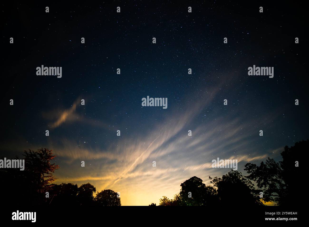 clouds, plain trails and stars in the night Stock Photo - Alamy