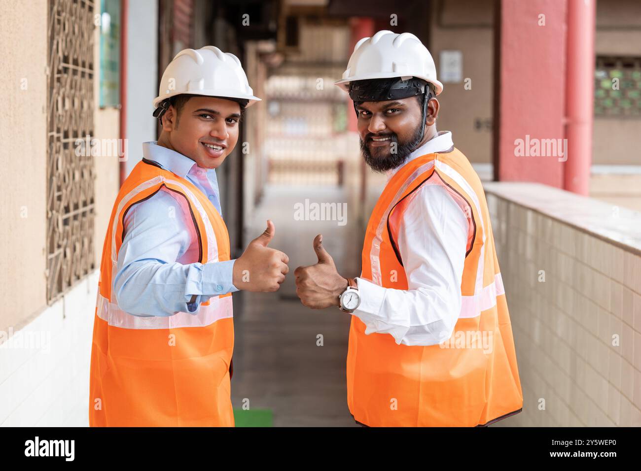 Two professional Indian engineers and foreman giving thumbs-up, symbol ...
