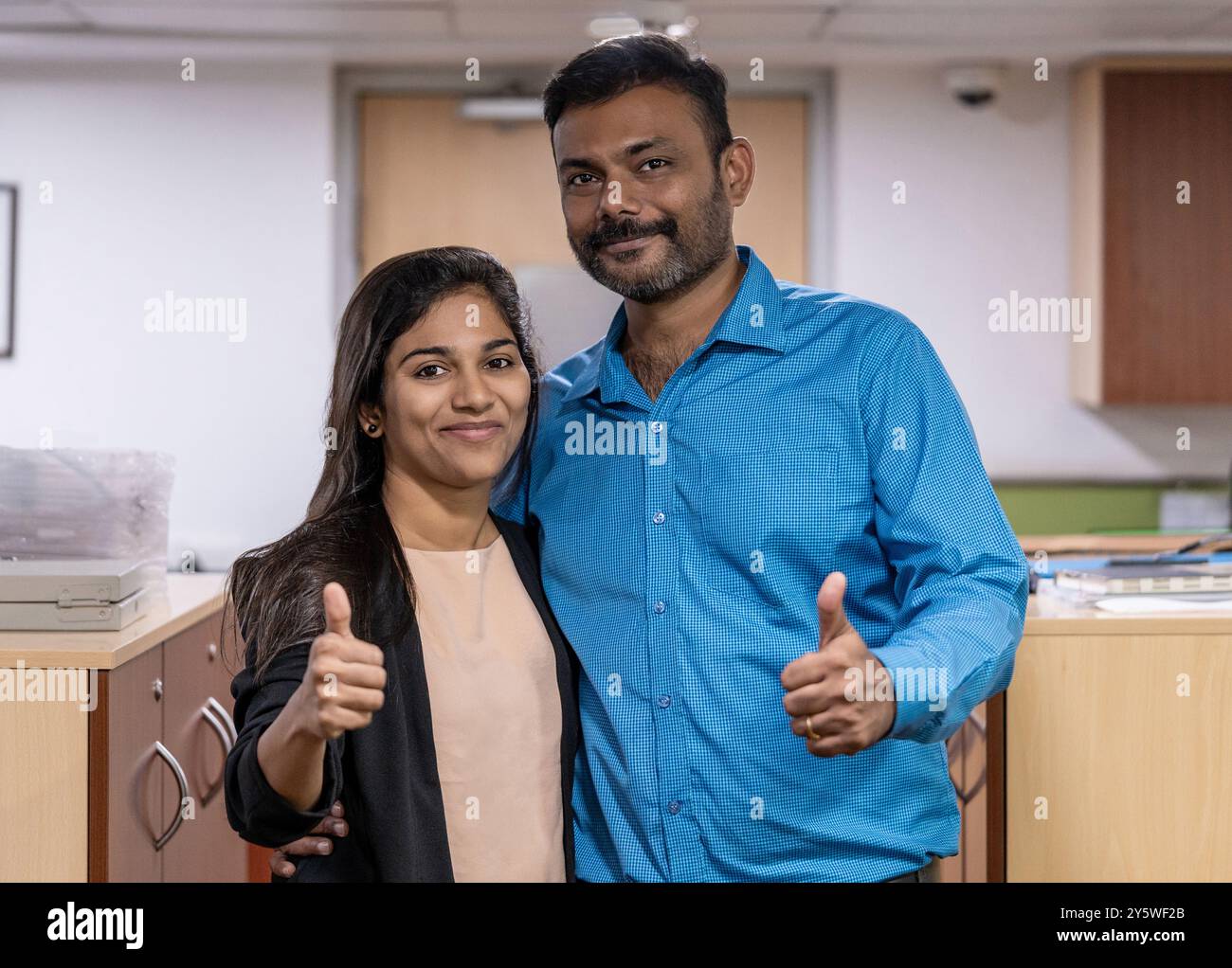 Happy Indian couple with a natural look family, business couple giving ...