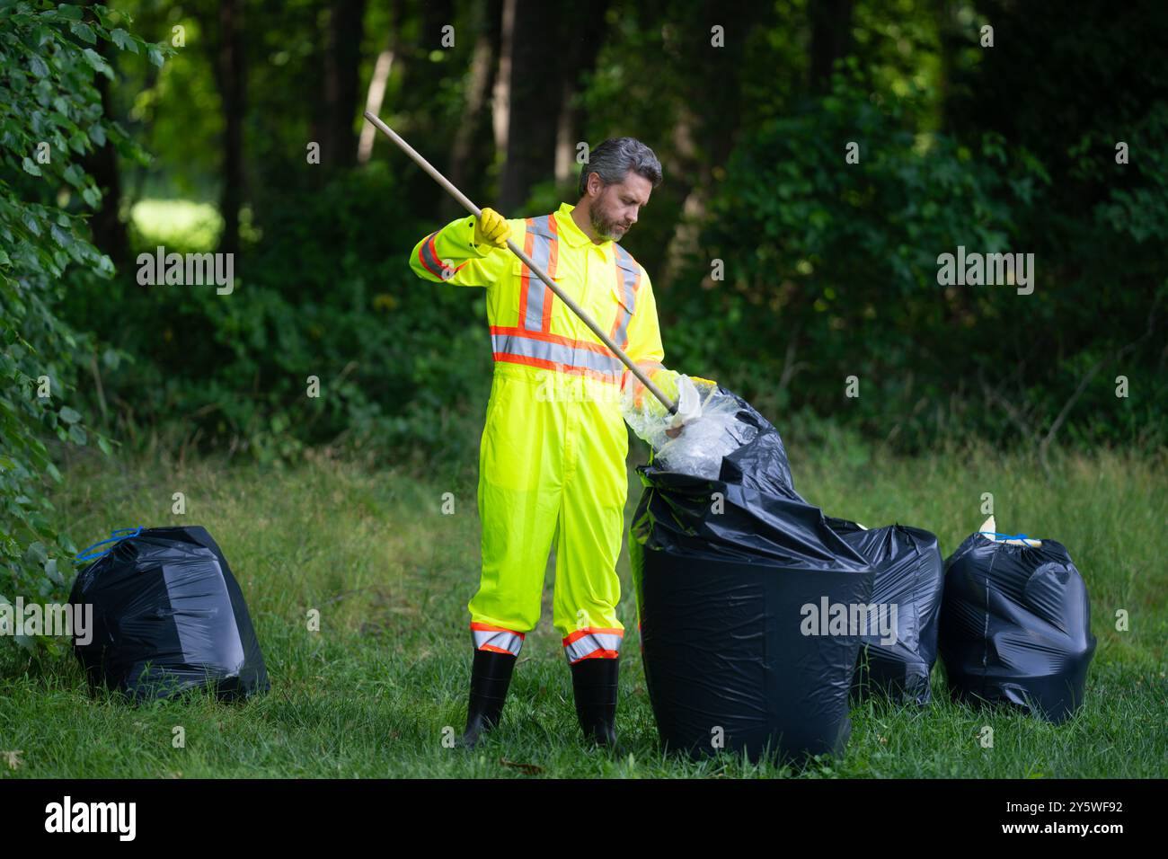 Volunteer man collecting trash outside. Ecology concept. Environmental ...