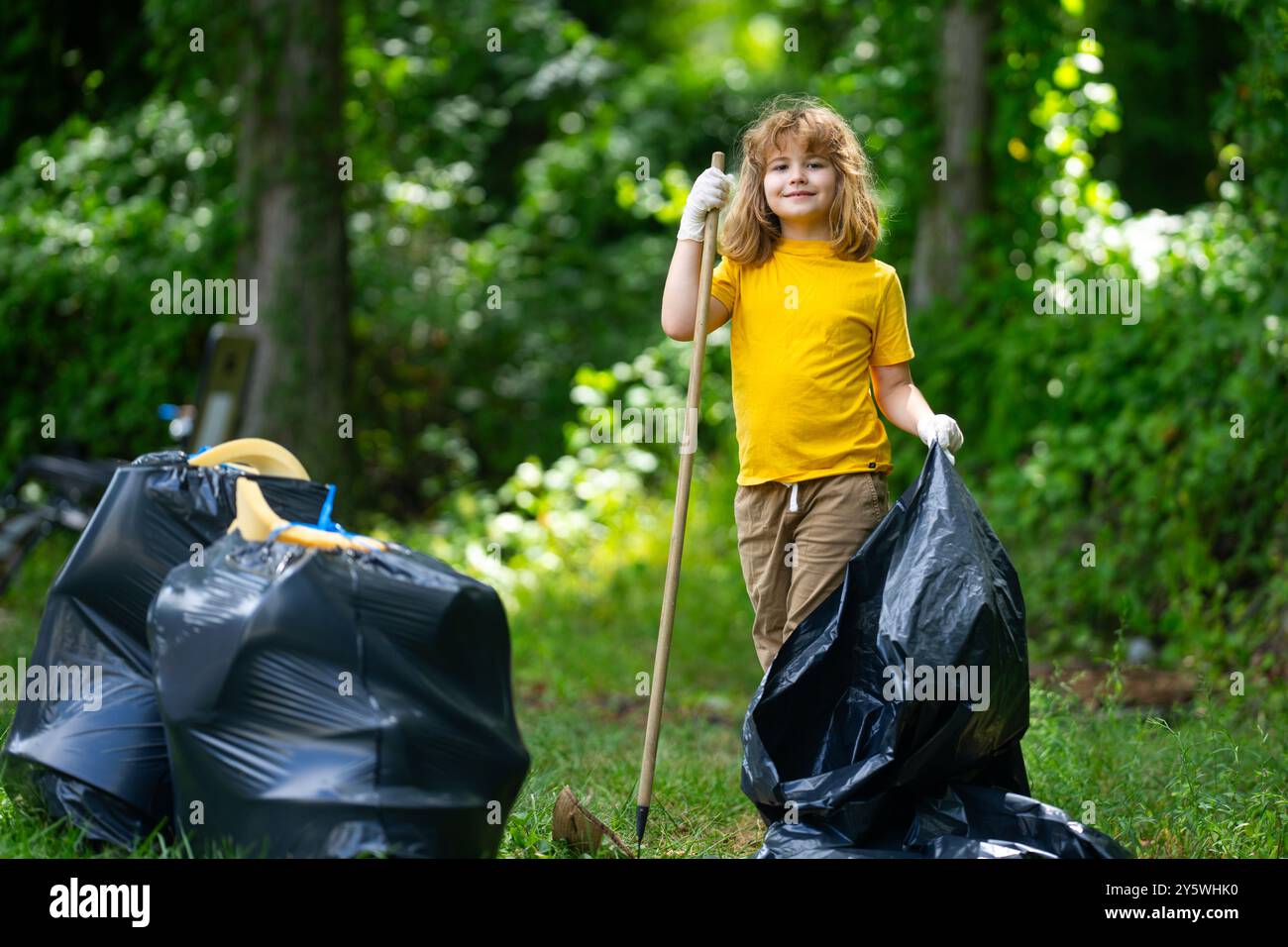 Kid helps to pick up garbage. Pollute forest. Rubbish trash. Planet ...