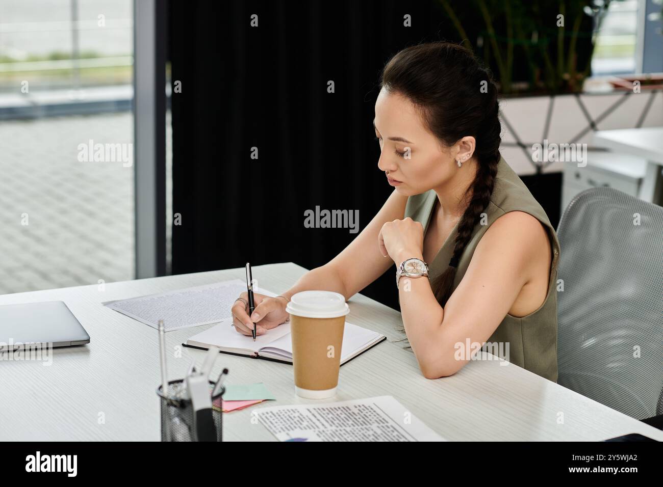 A dedicated professional writes in her notebook, surrounded by an ...
