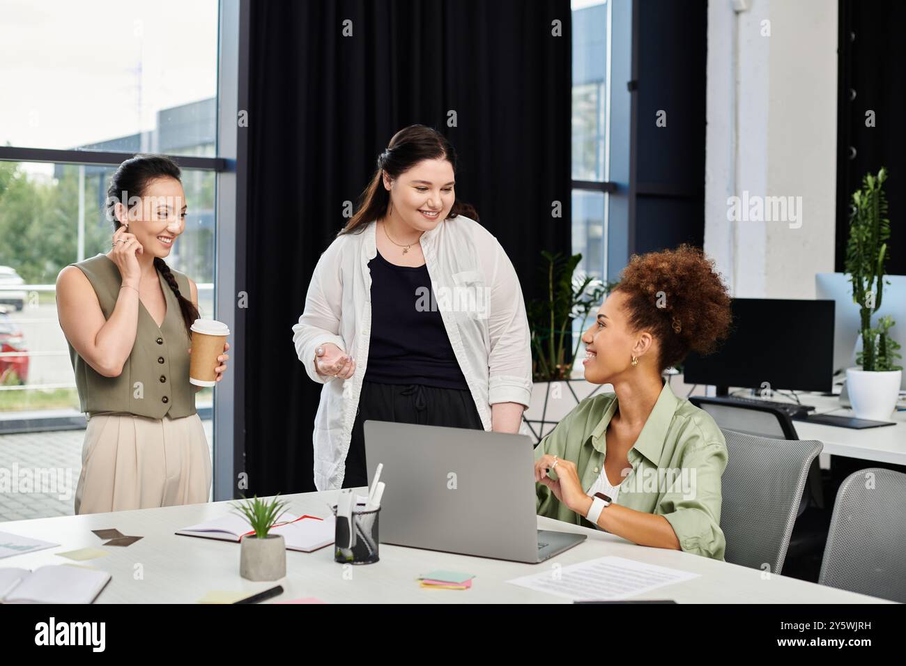 Three professional women engage in an inspiring discussion while ...