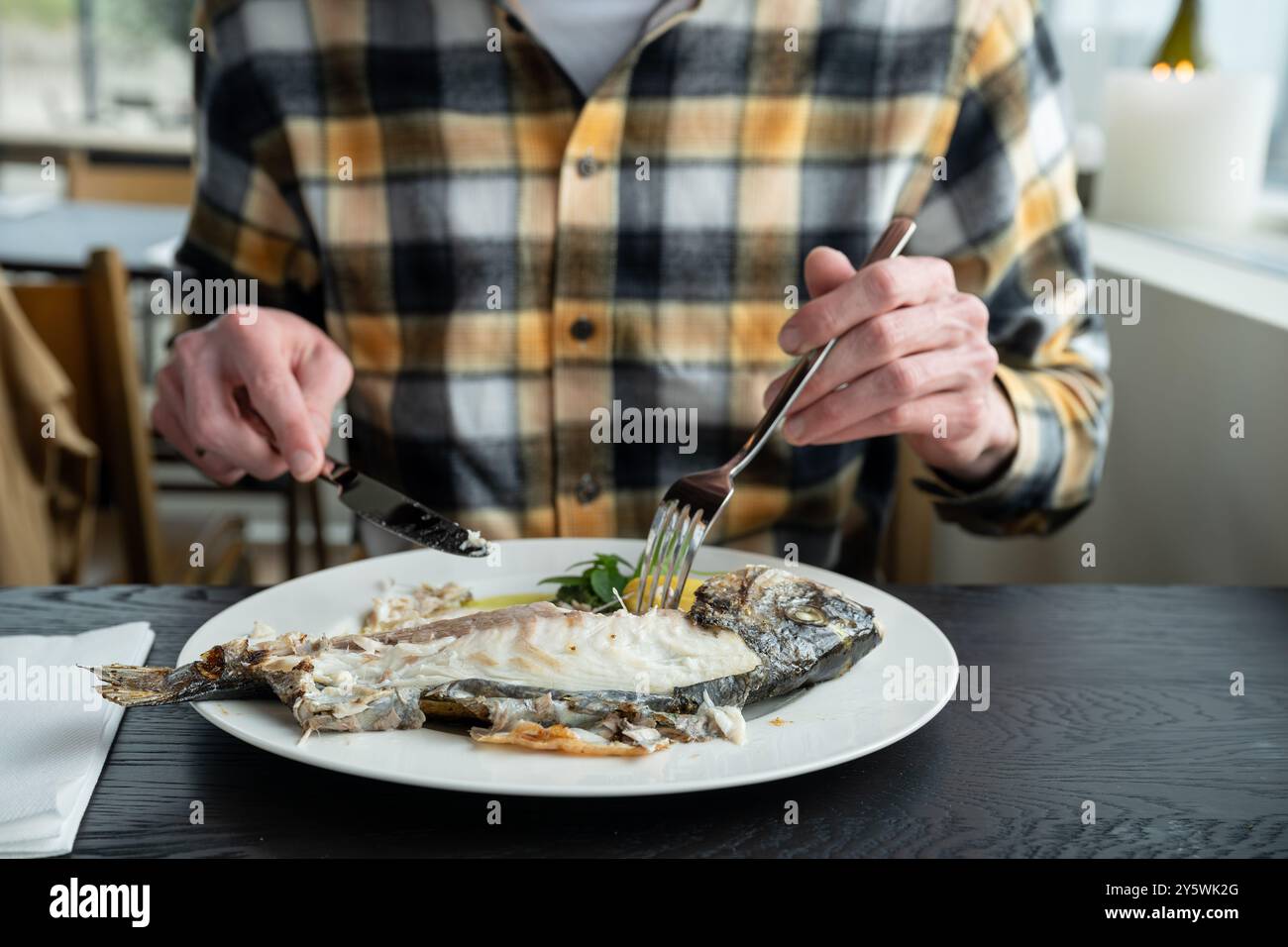 Man eating fish hi-res stock photography and images - Alamy