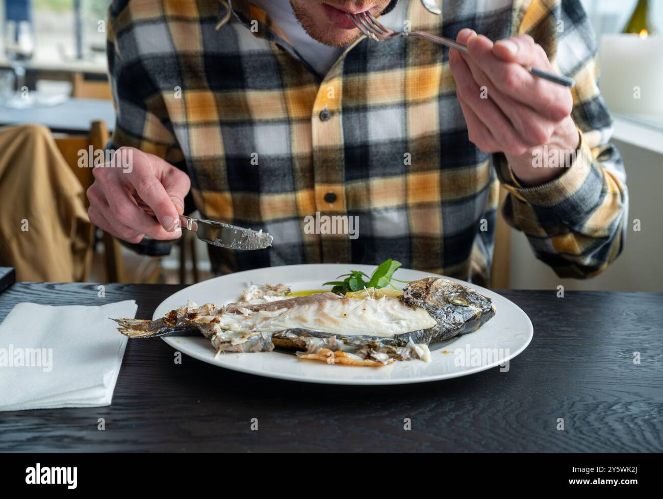 Man eating fish hi-res stock photography and images - Alamy
