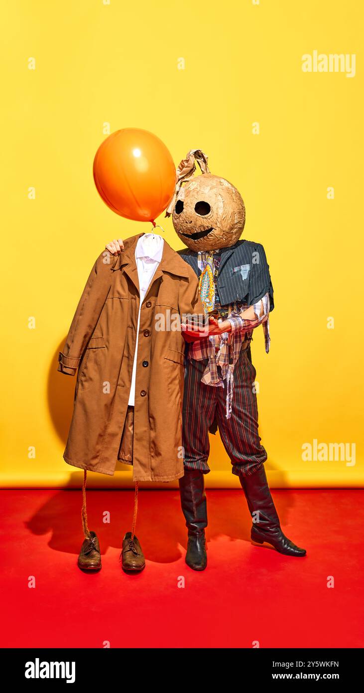 Person in creepy ripped costume and mask, standing next to mannequin ...