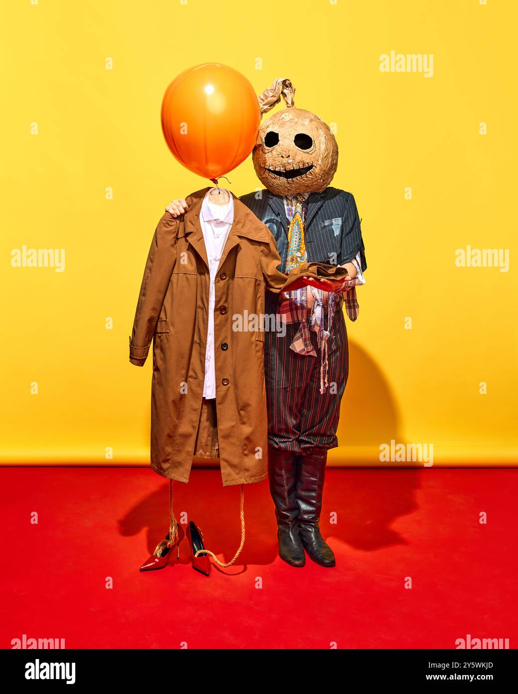 Person in creepy ripped costume and mask, standing next to mannequin ...
