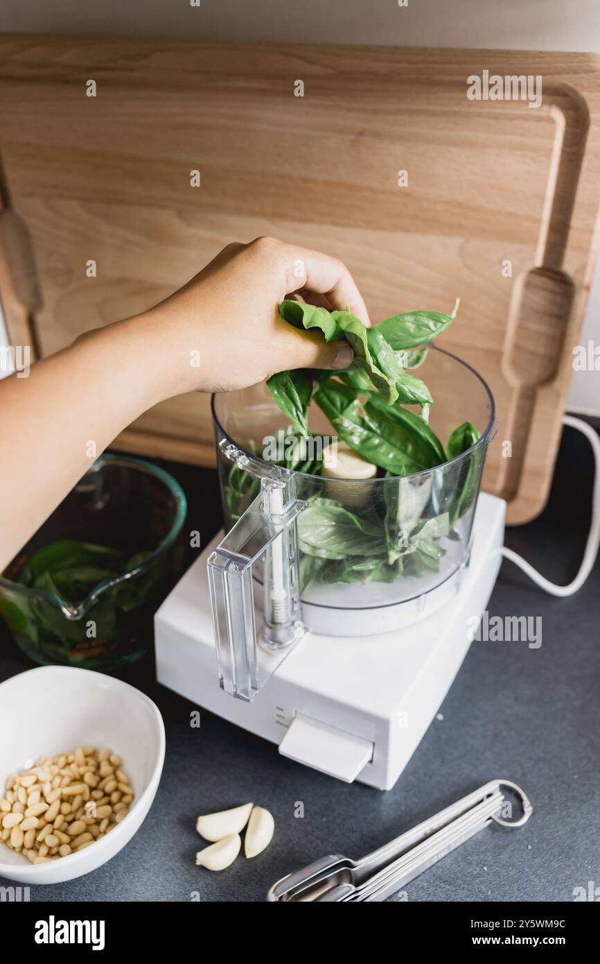 Female adding basil leaves italian hi-res stock photography and images ...