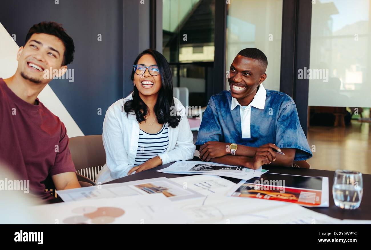 Multiethnic classmates enjoying a happy and engaging study session ...