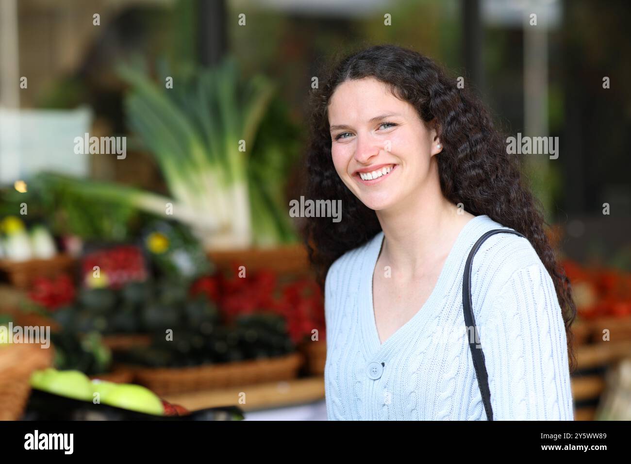 Happy client in a greengrocery standing looking at camera Stock Photo ...