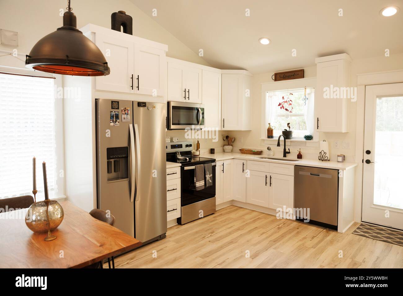Modern kitchen interior with stainless steel appliances, white ...