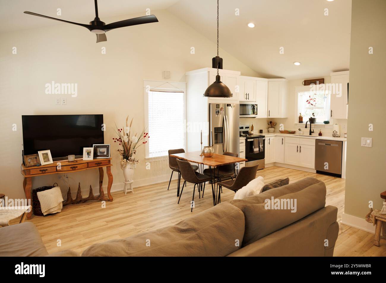 Modern living room seamlessly connected to a well-equipped kitchen with ...